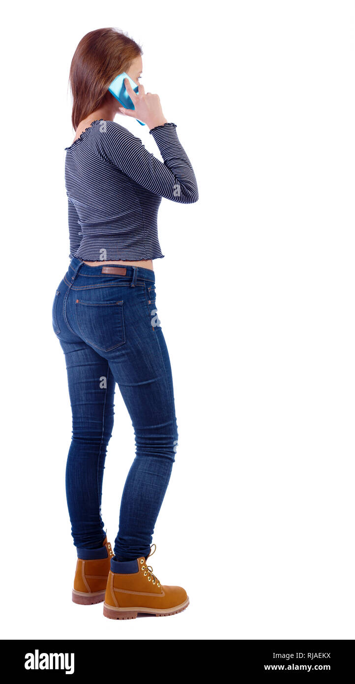 back view of a woman talking on the phone. backside view of person ...