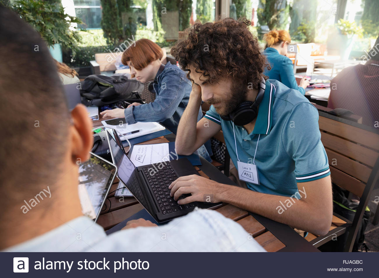 Focused male hacker working at laptop during hackathon Stock Photo - Alamy