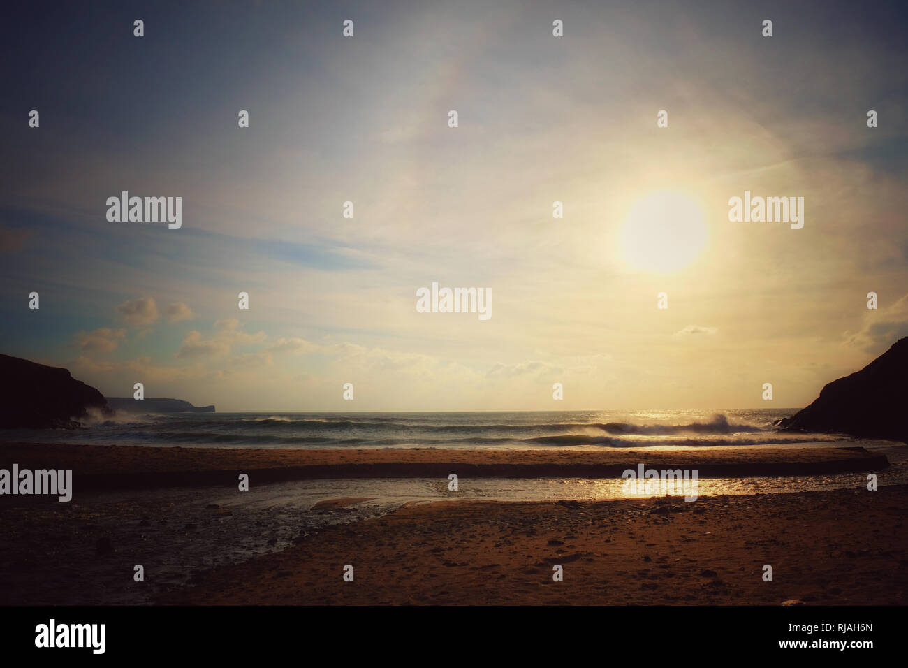 Setting sun at Gunwalloe Church Cove, on the Lizard Peninsula, Cornwall ...