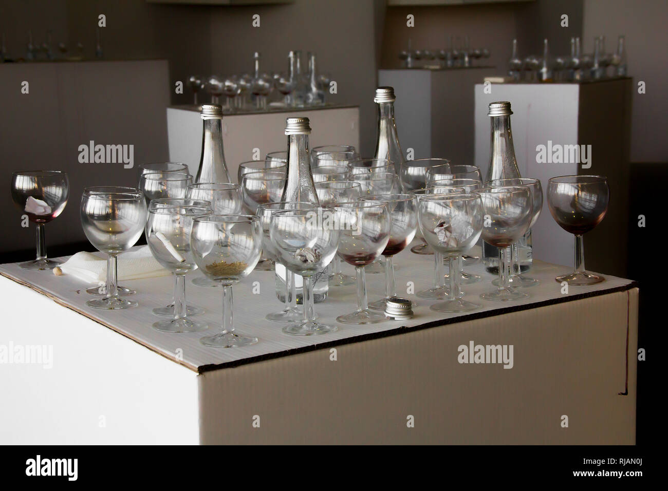 Wine glasses and bottles on the table after the exhibition opening and ...