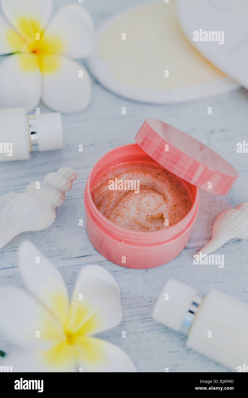 spa inspired set of scrub body lotions surrounded by flowers and ...