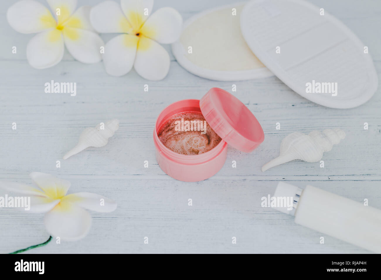spa inspired set of scrub body lotions surrounded by flowers and ...