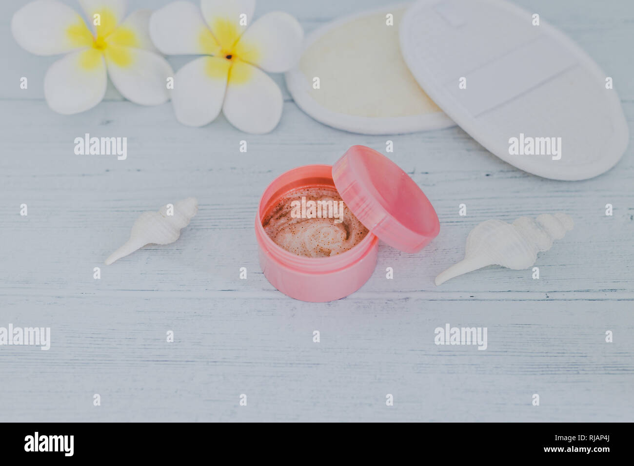 spa inspired set of scrub body lotions surrounded by flowers and ...