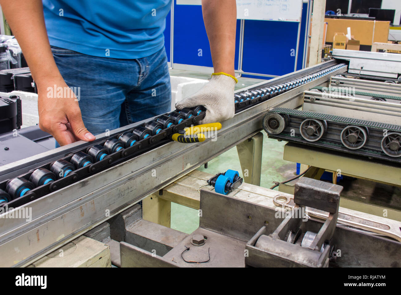 worker maintenance and repair conveyor belt in factory Stock Photo - Alamy