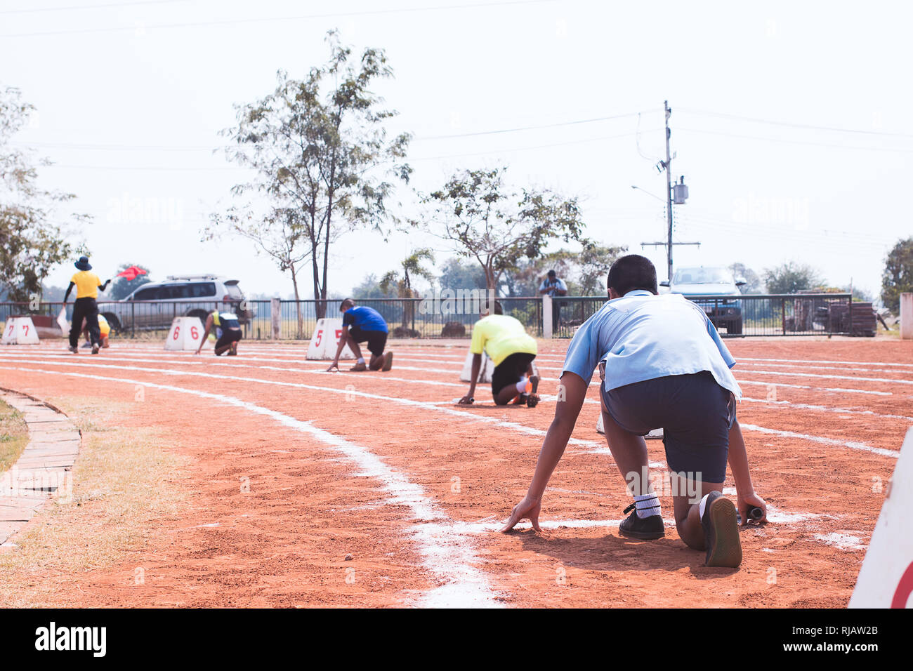 Back view of students ready to start run on running track Stock Photo ...