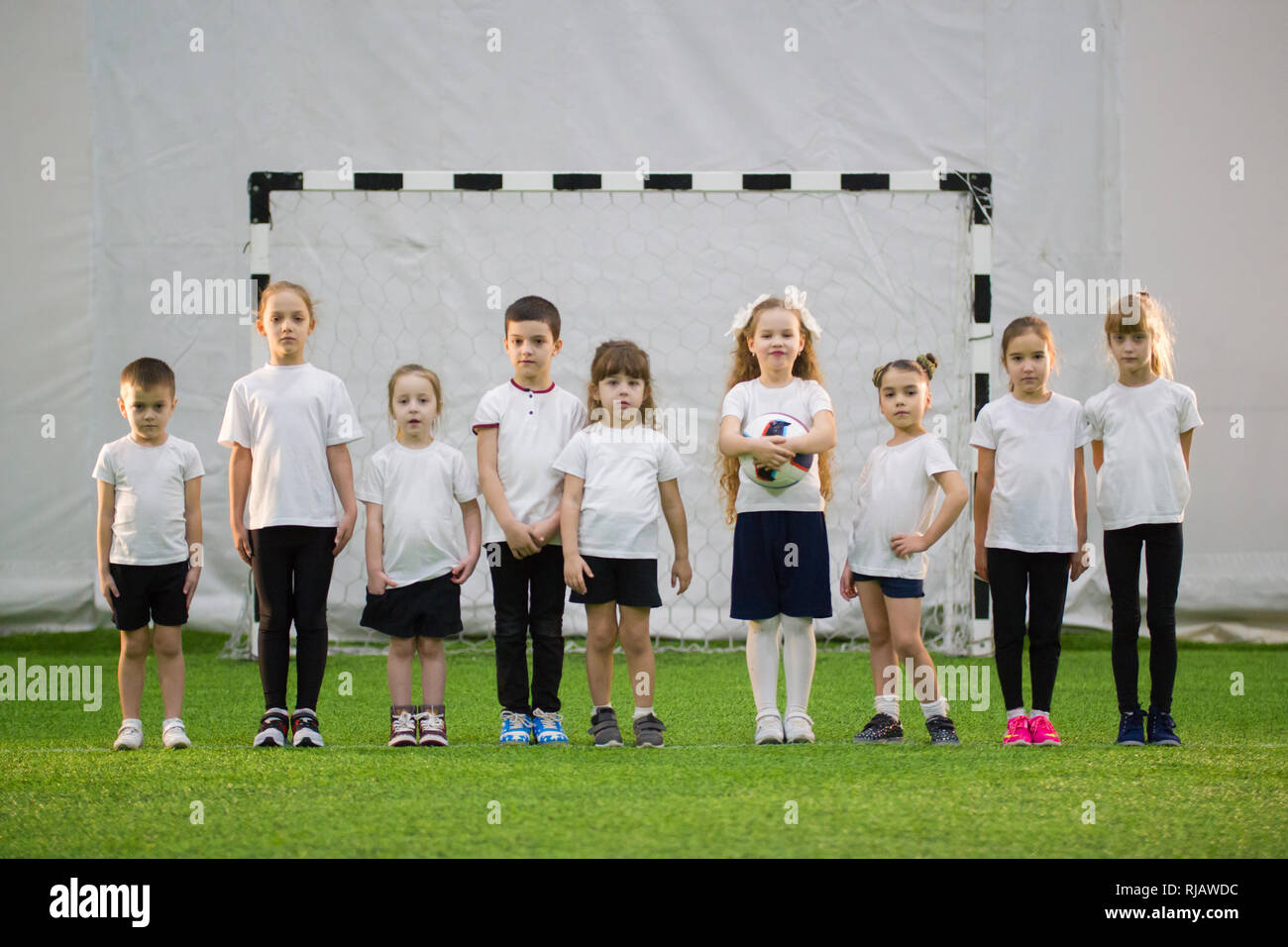 Little kids playing football indoors. Children stand in the line Stock ...