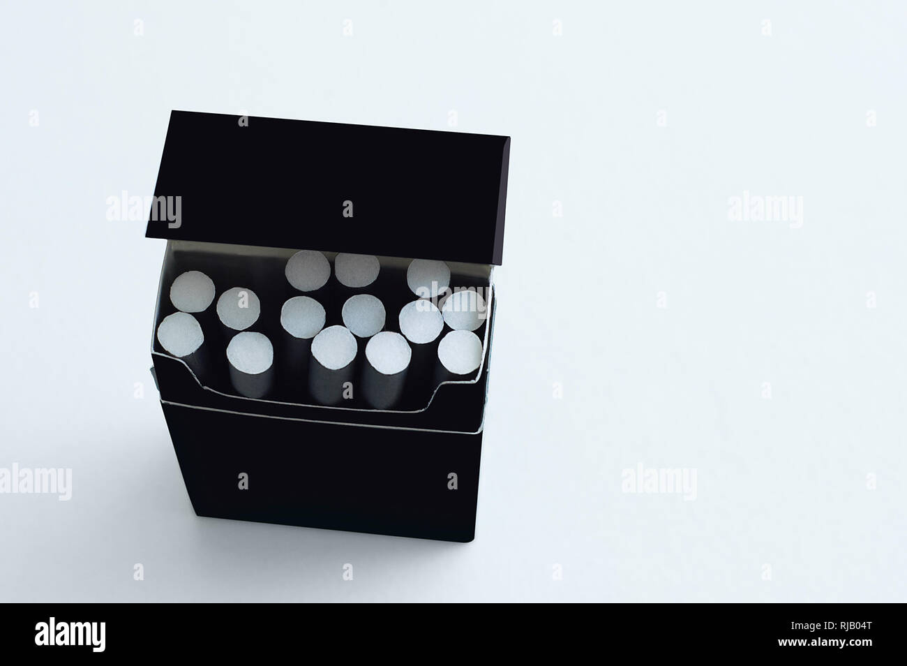 The black pack with cigarettes costs on a white background Stock Photo ...