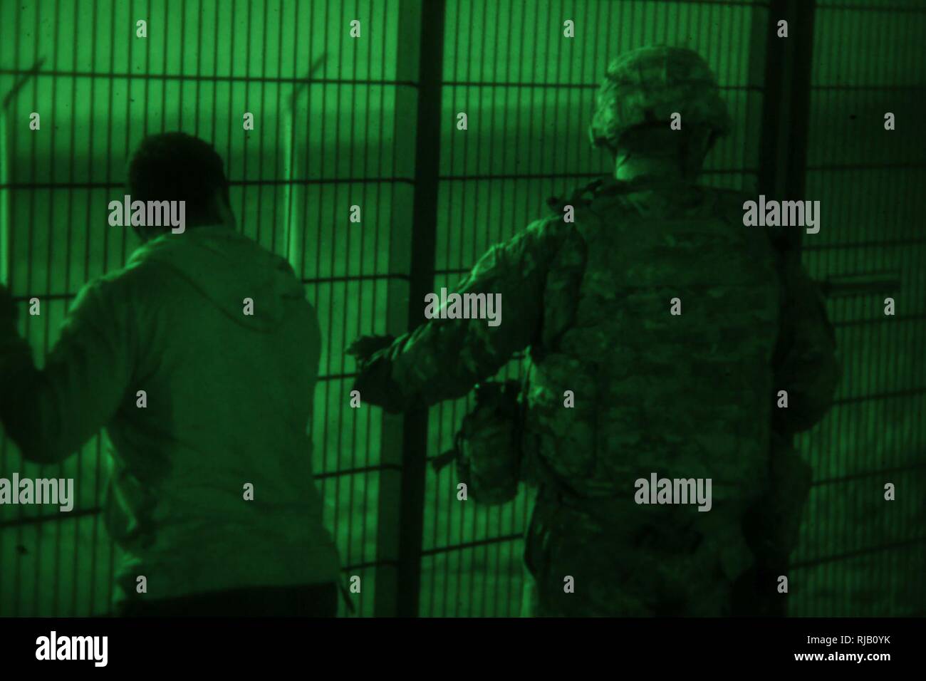 A U.S. Soldier of 591st Military Police Company calms a civilian role ...