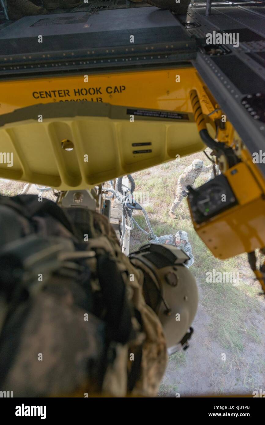 Soldiers assigned to 3rd Division Artillery hook up a Humvee and ...
