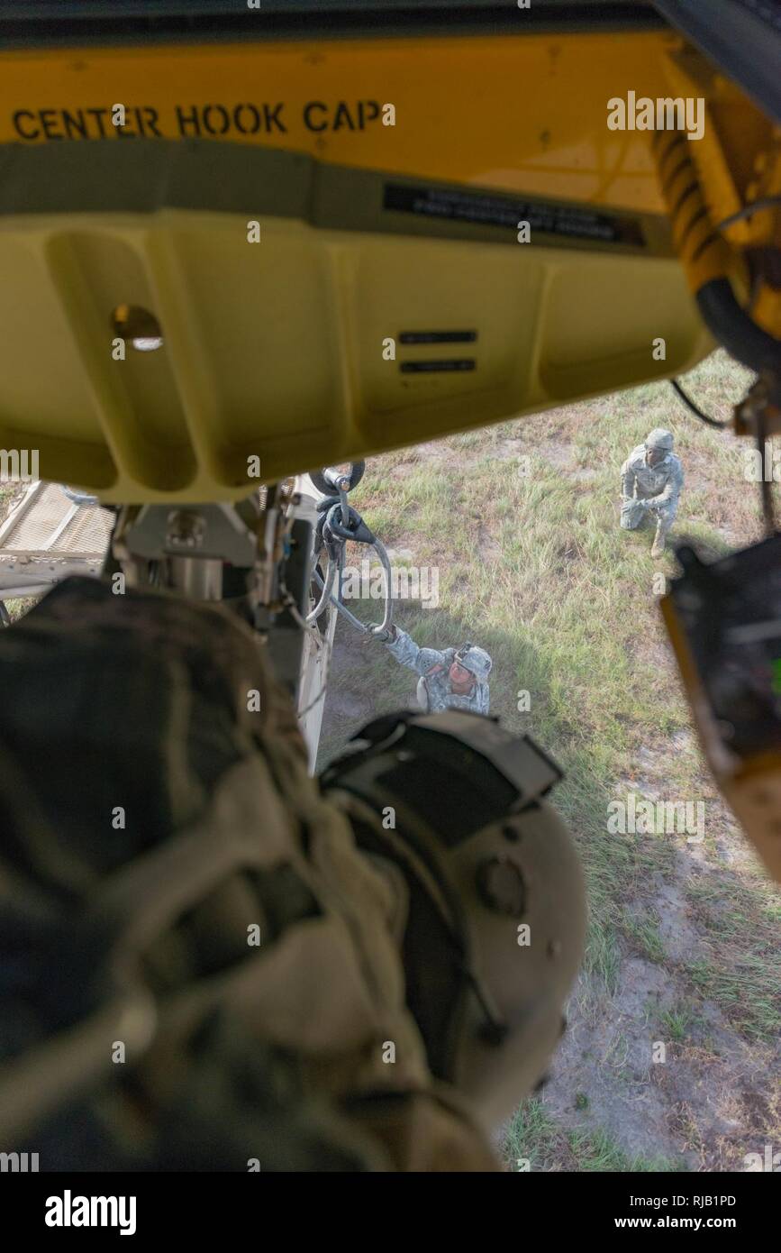 Soldiers assigned to 3rd Division Artillery hook up a Humvee and ...