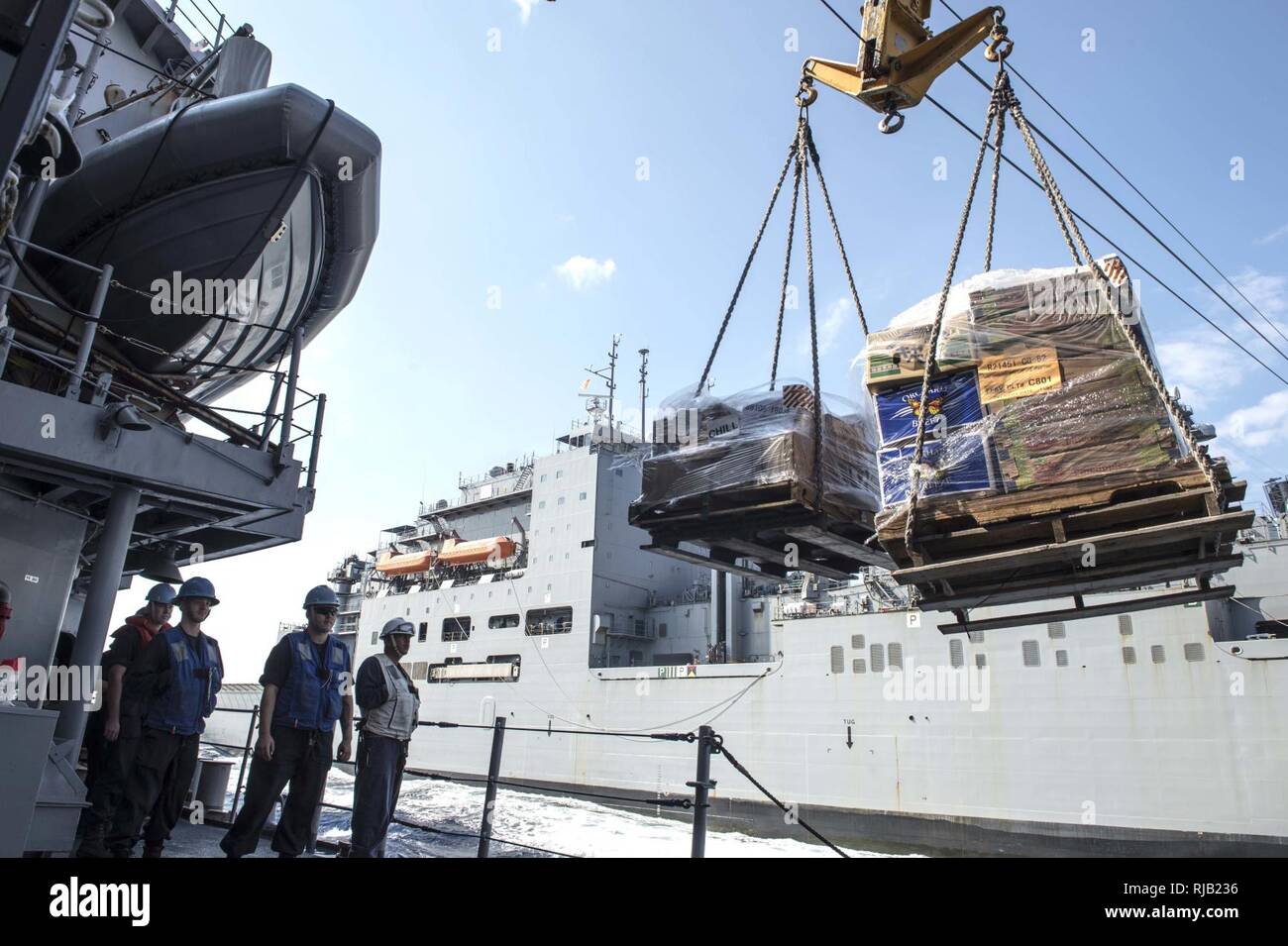 PHILIPPINE SEA (Nov. 5, 2016) Sailors wait for cargo aboard the ...