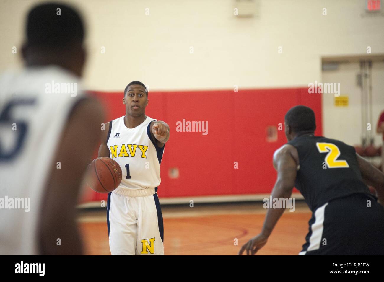 U.S. Navy Ensign Earl McLaurin, guard, Navy basketball team, points to ...