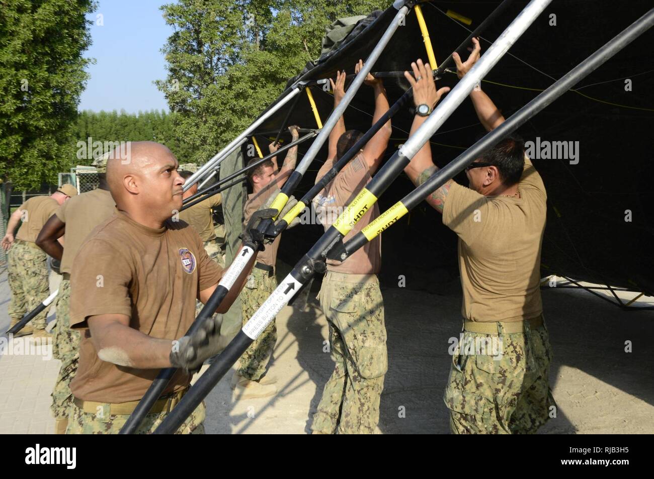 Sailors attached to Commander, Task Force (CTF) 56, set up tents during ...