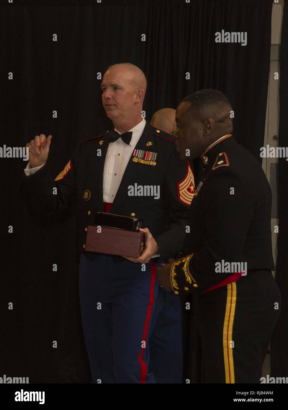U.S. Marine Corps Sgt. Maj. Joseph Gray is presented with a gift during ...