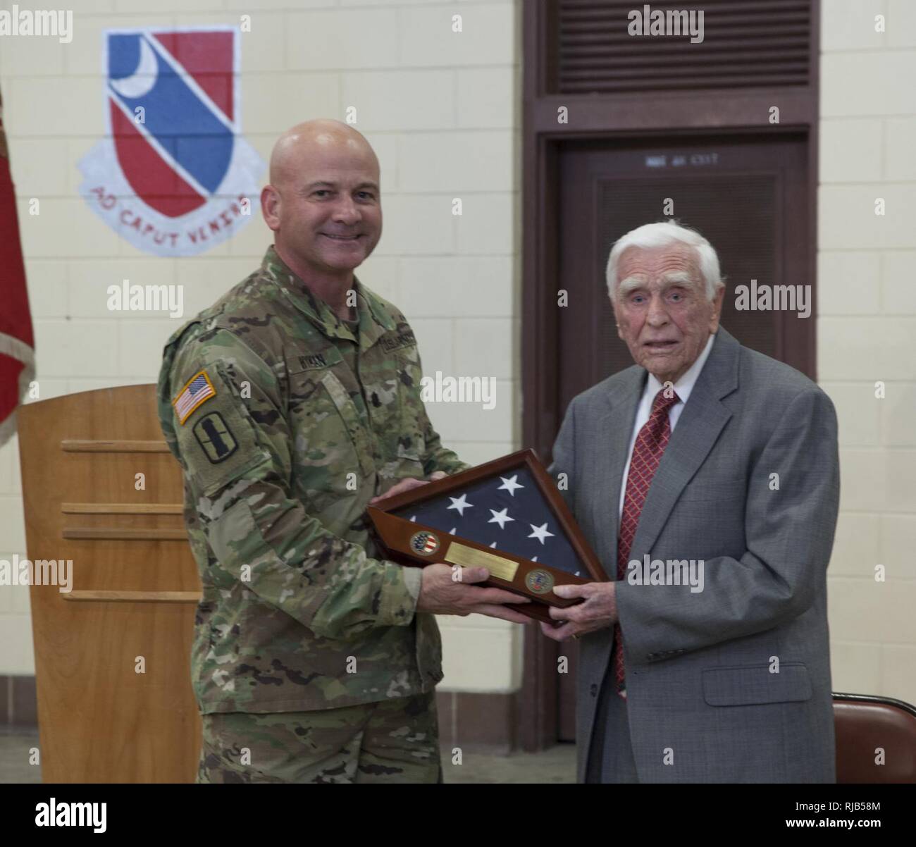 Mr. William Zimmerman receives a U.S. Flag from U.S. Army Lt. Col. Christopher Hyman, 122nd ...