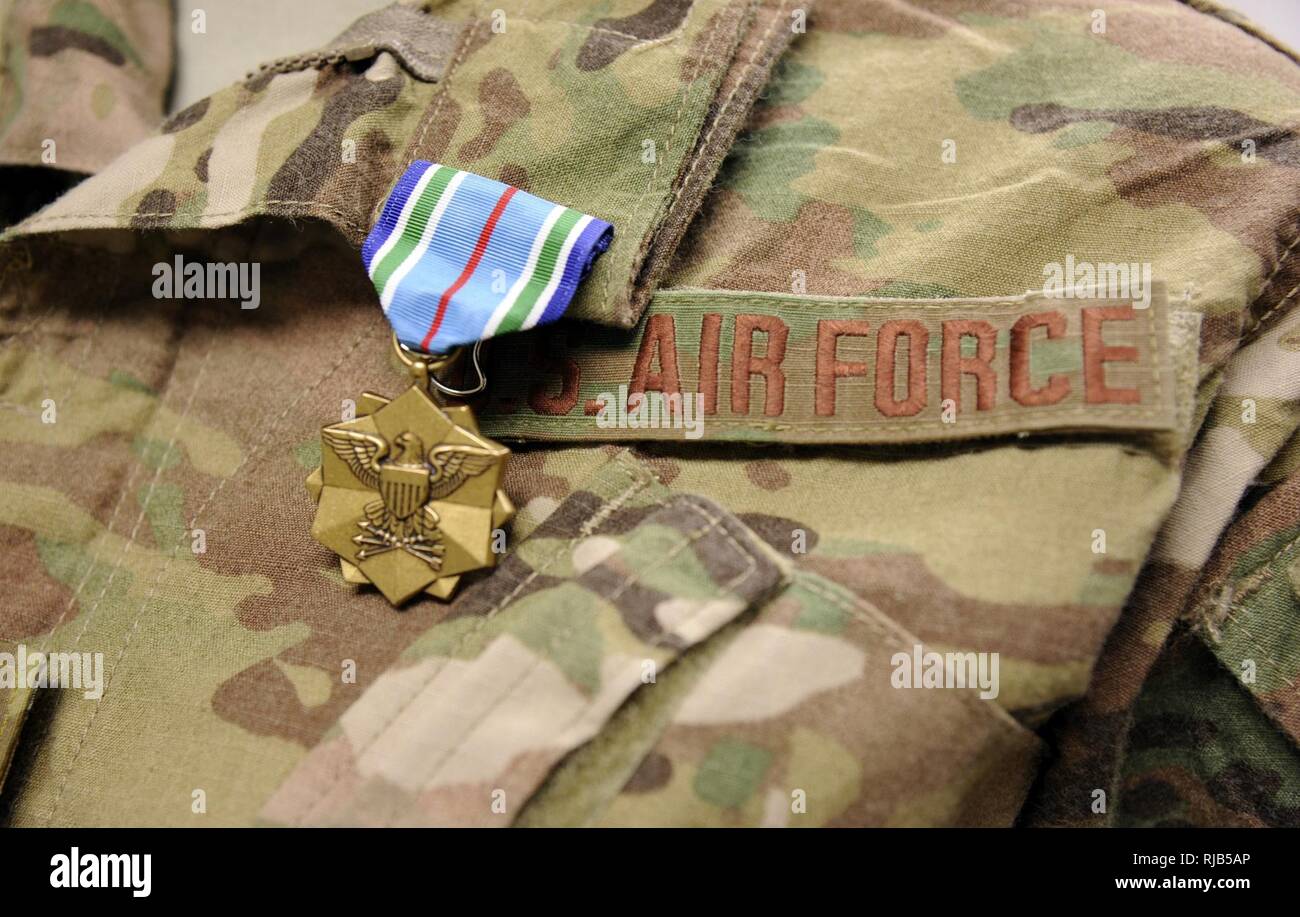 A Joint Service Achievement Medal is pinned on the uniform of one of ...