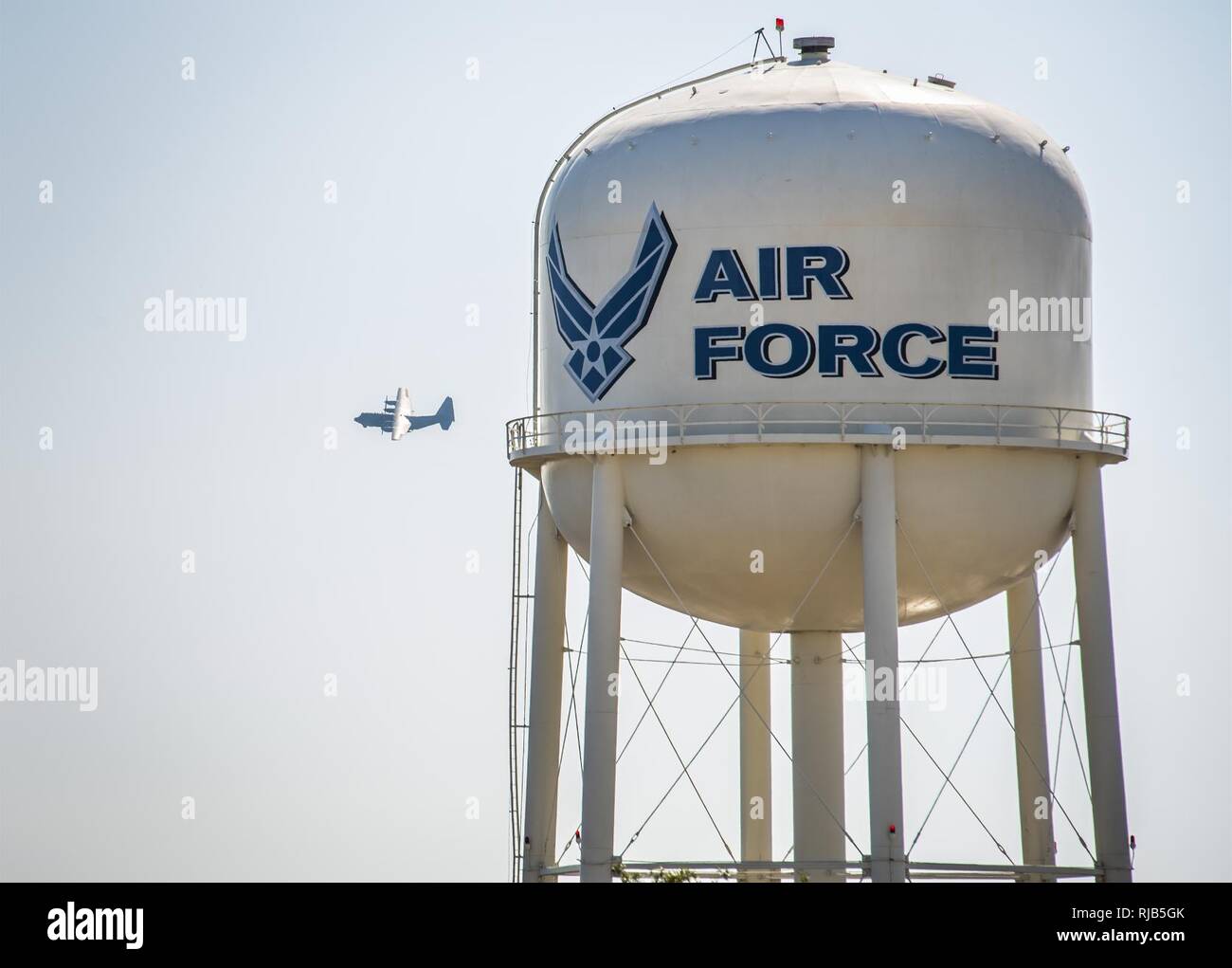 A C-130 passes by a water tower while performing approaches to the ...