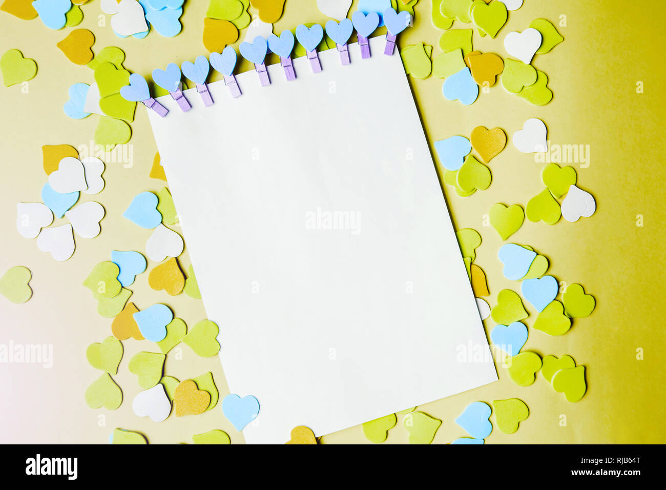 Beautiful yellow background with green, blue hearts and blank, A4 paper ...