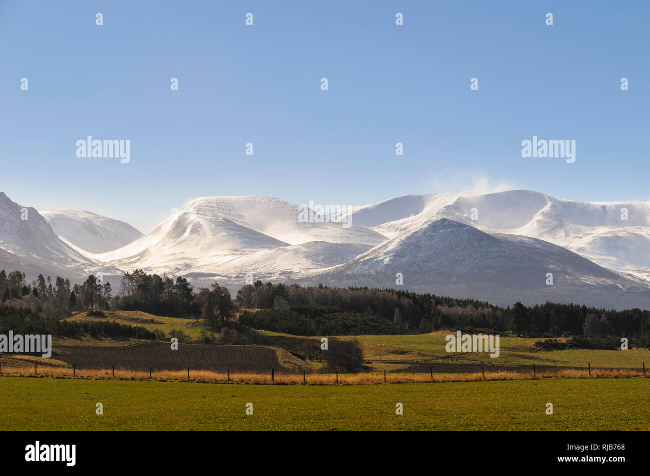 Spindrift blowing off the snow-capped peaks of Creag nan Gall and Stac ...