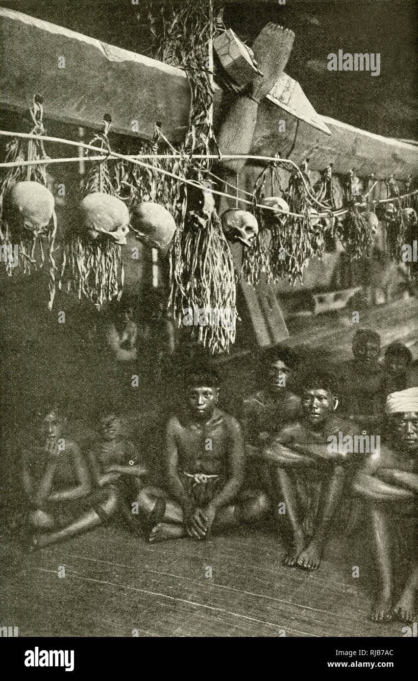 Kayan men in long house with skulls, Borneo, SE Asia Stock Photo - Alamy