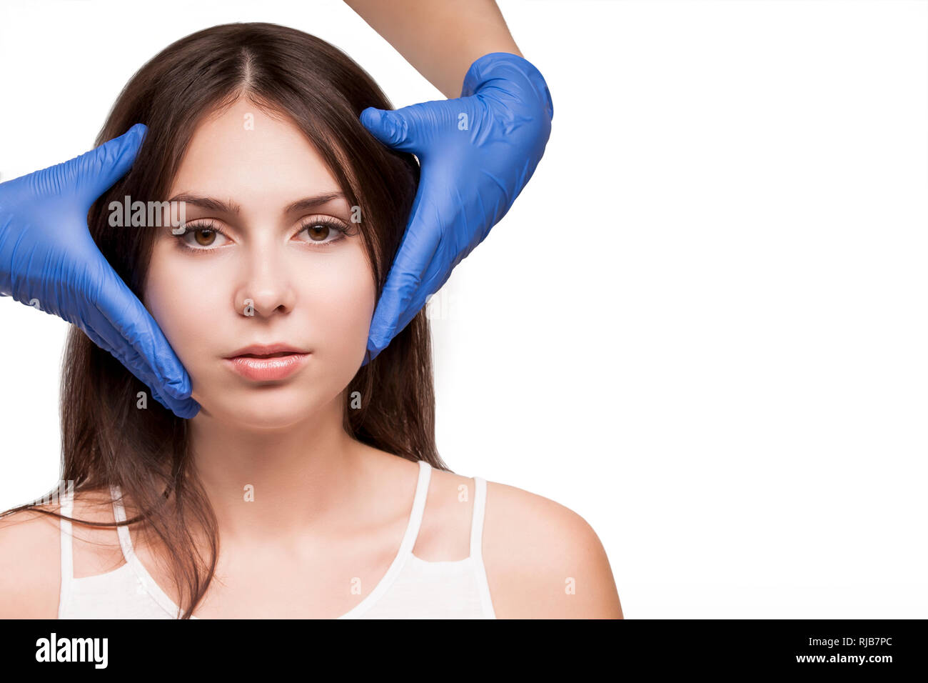 Beautiful girl model. Plastic surgery touching the beautiful face of a ...