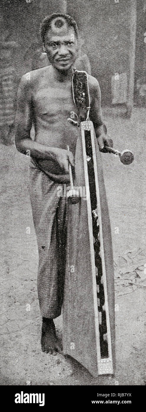 Tribesman playing tattoo, French Congo, Central Africa Stock Photo - Alamy