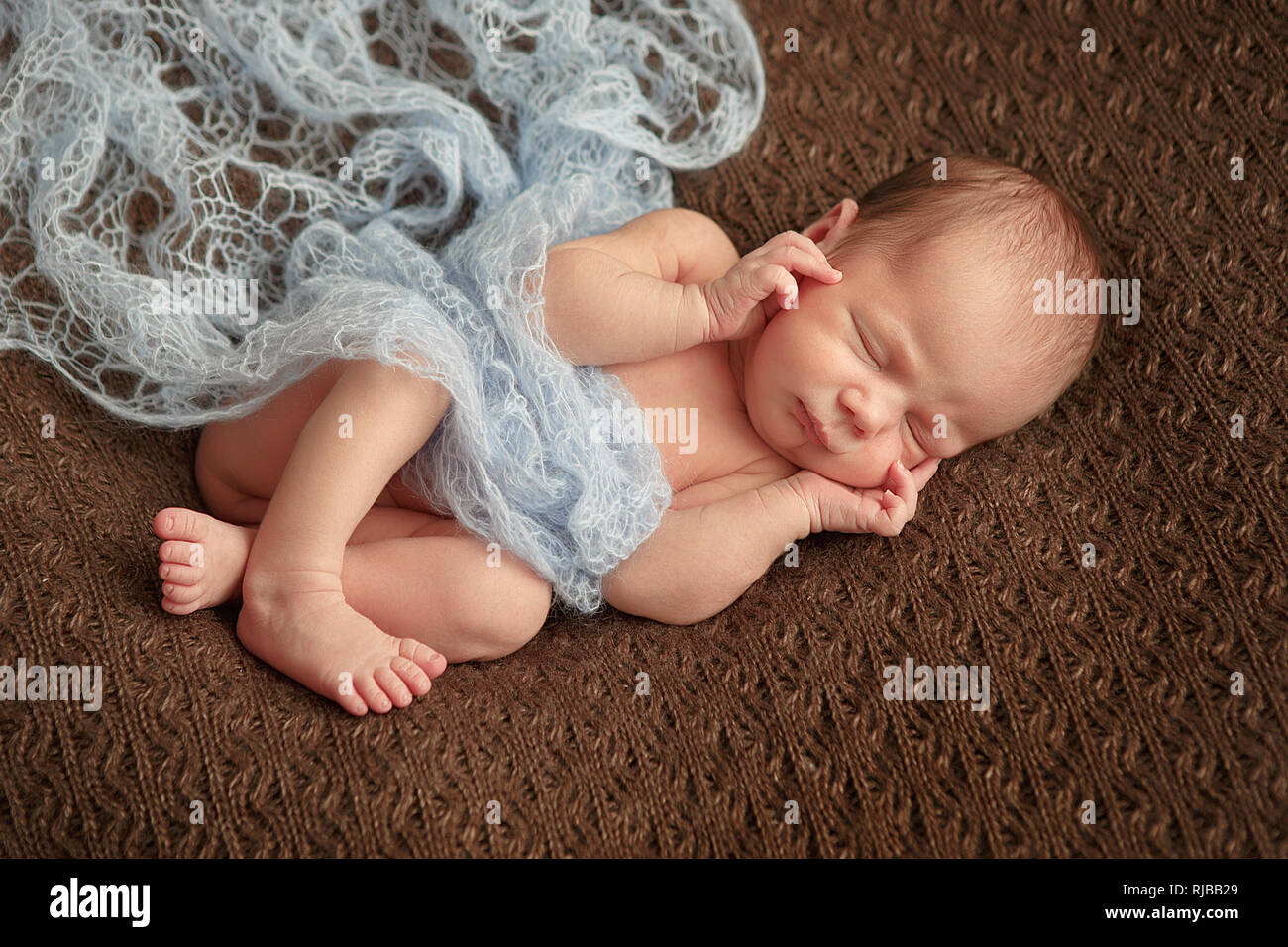Newborn baby tender sleeping on wool couturier blanket. Pure human ...