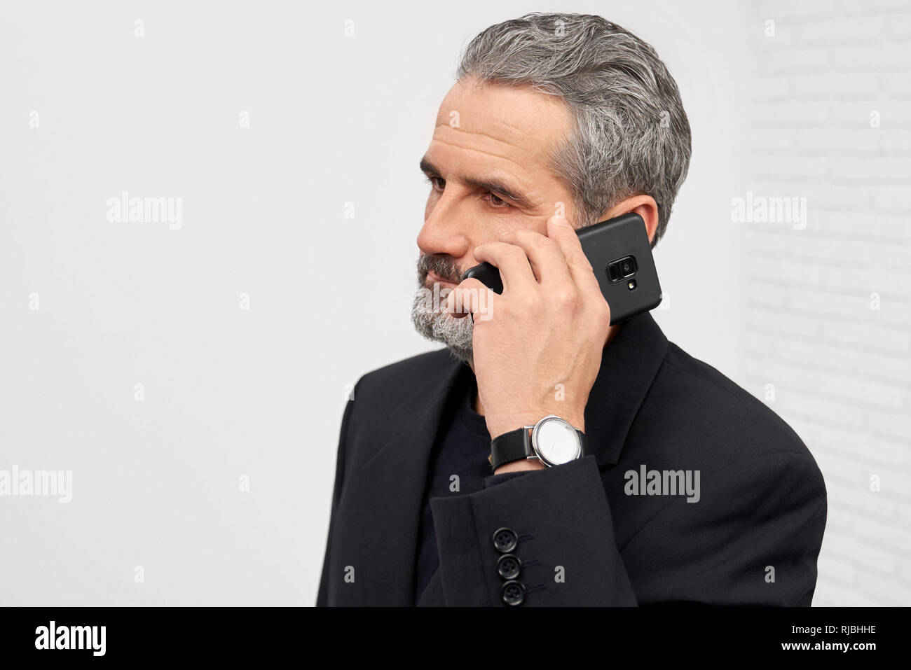 Man with suit and watch on hand hi-res stock photography and images - Alamy