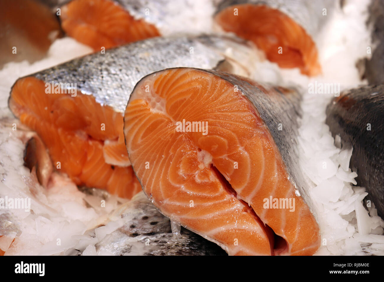 Fresh pink salmon steaks in the ice. Raw red fish in the market ...