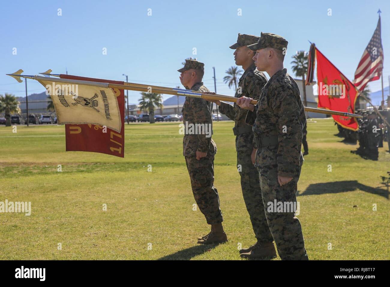 A platoon from 1st Battalion, 7th Marine Division, gives a guidon ...