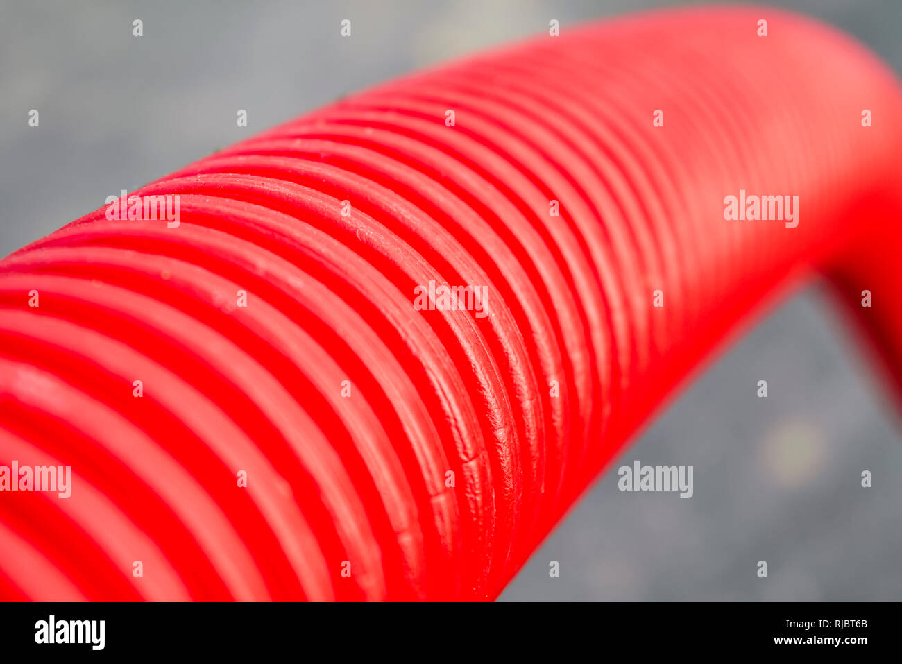 Red PVC corrugated pipes for cable lay on the construction site close ...