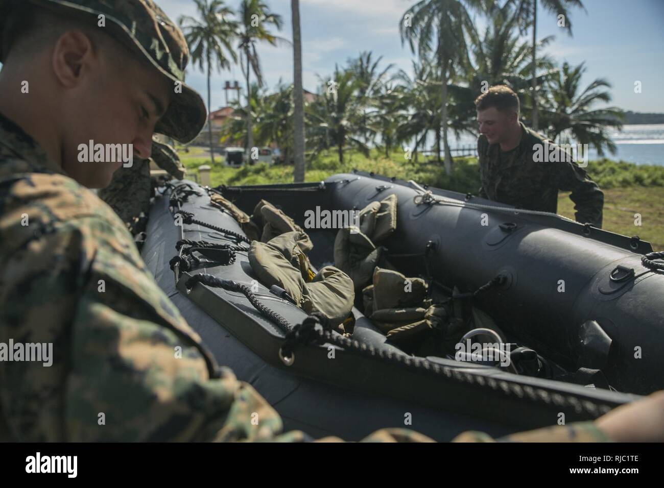 U.S. Marines secure a Combat Rubber Reconnaissance Craft (CRRC) onto a ...