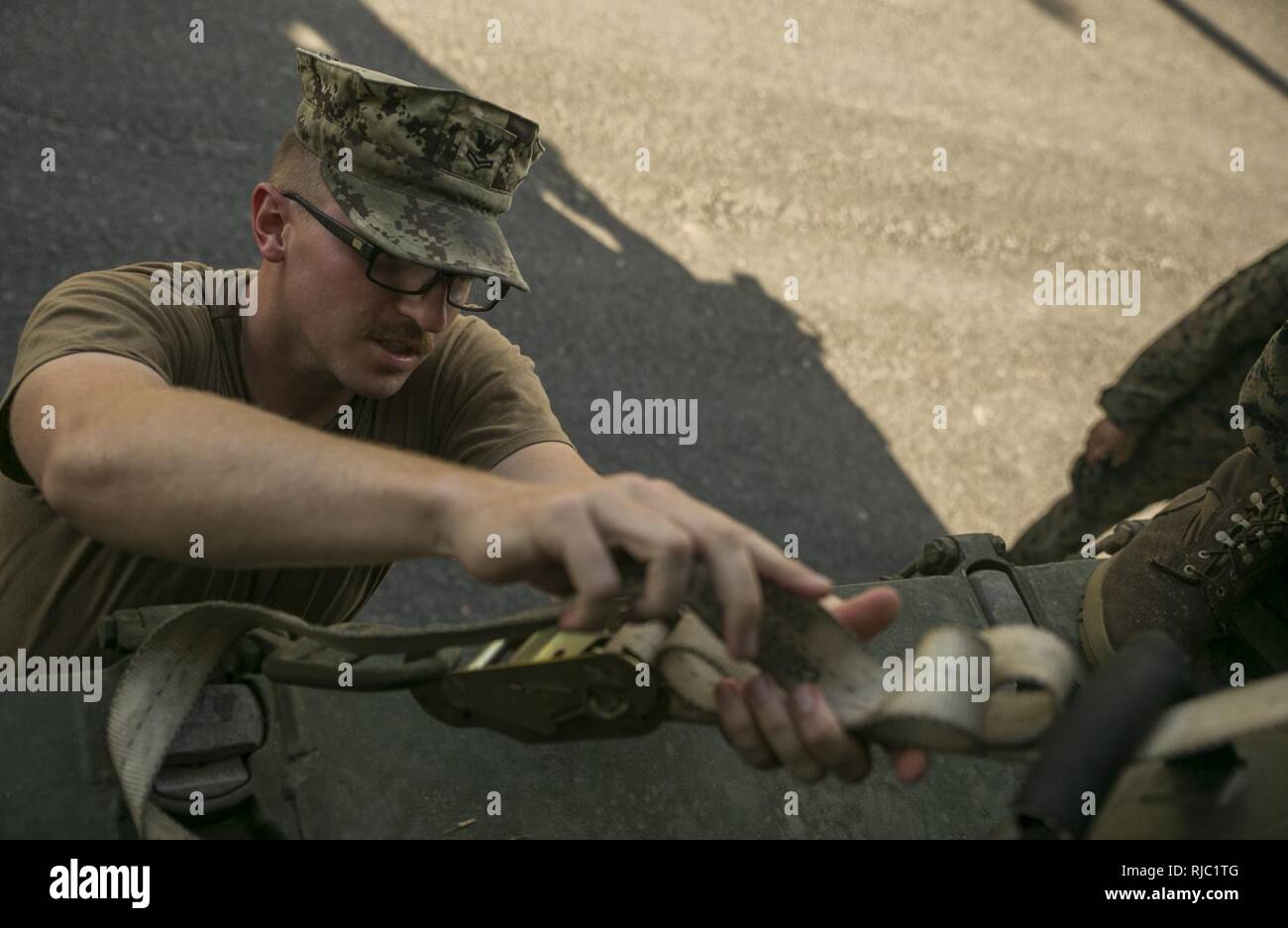 U.S. Navy Petty Officer 2nd Class Jacob Trevethan secures Combat Rubber ...