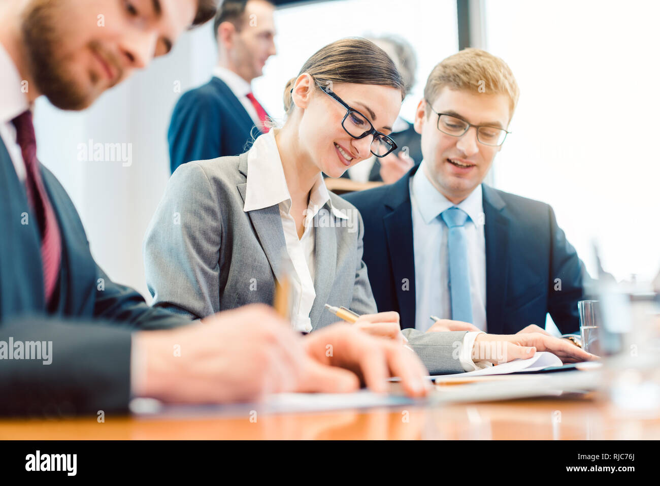 Businesspeople analyzing documents or reading a contract Stock Photo ...