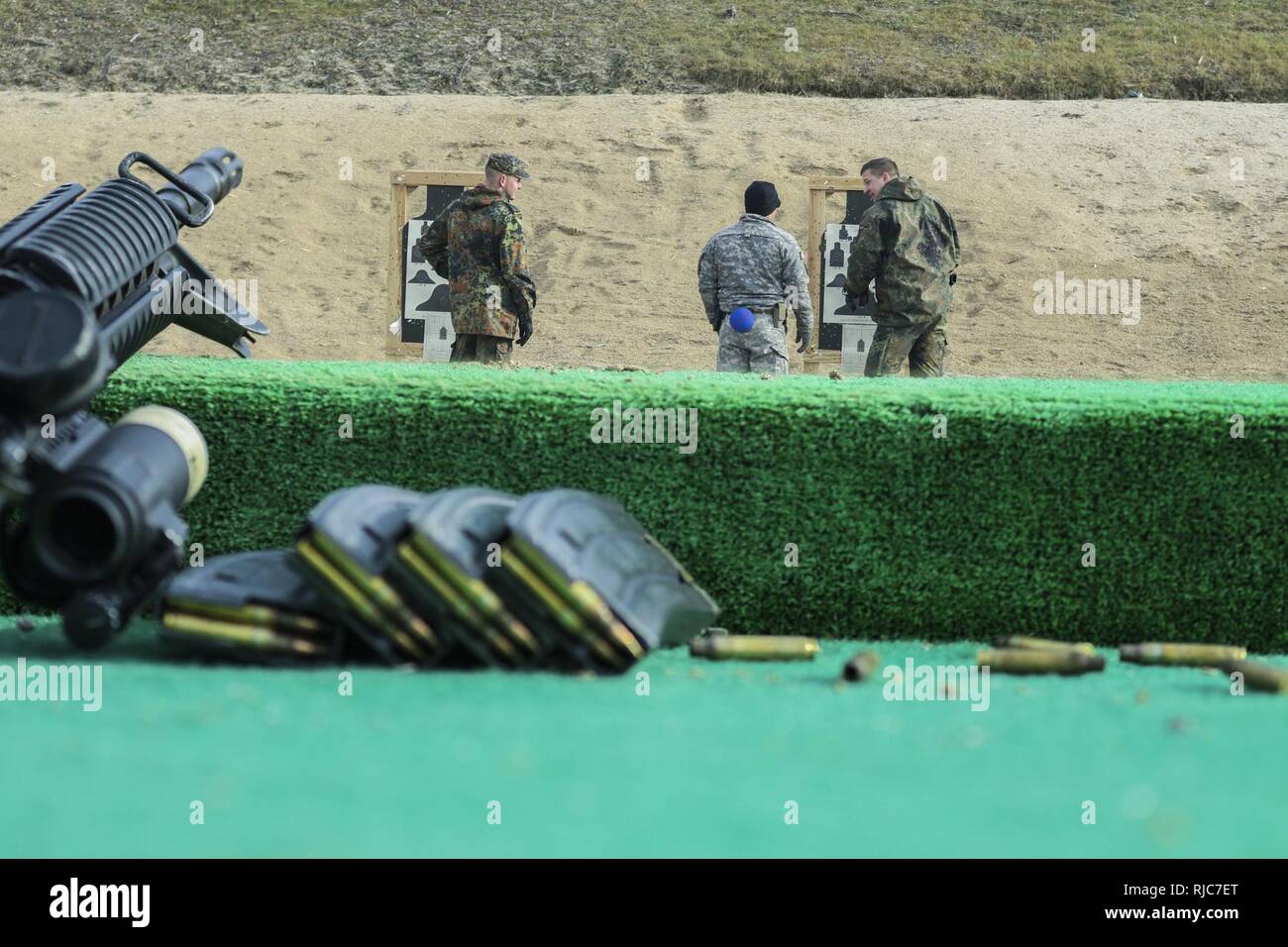 German and U.S. Soldiers inspect their targets to see who qualified for ...