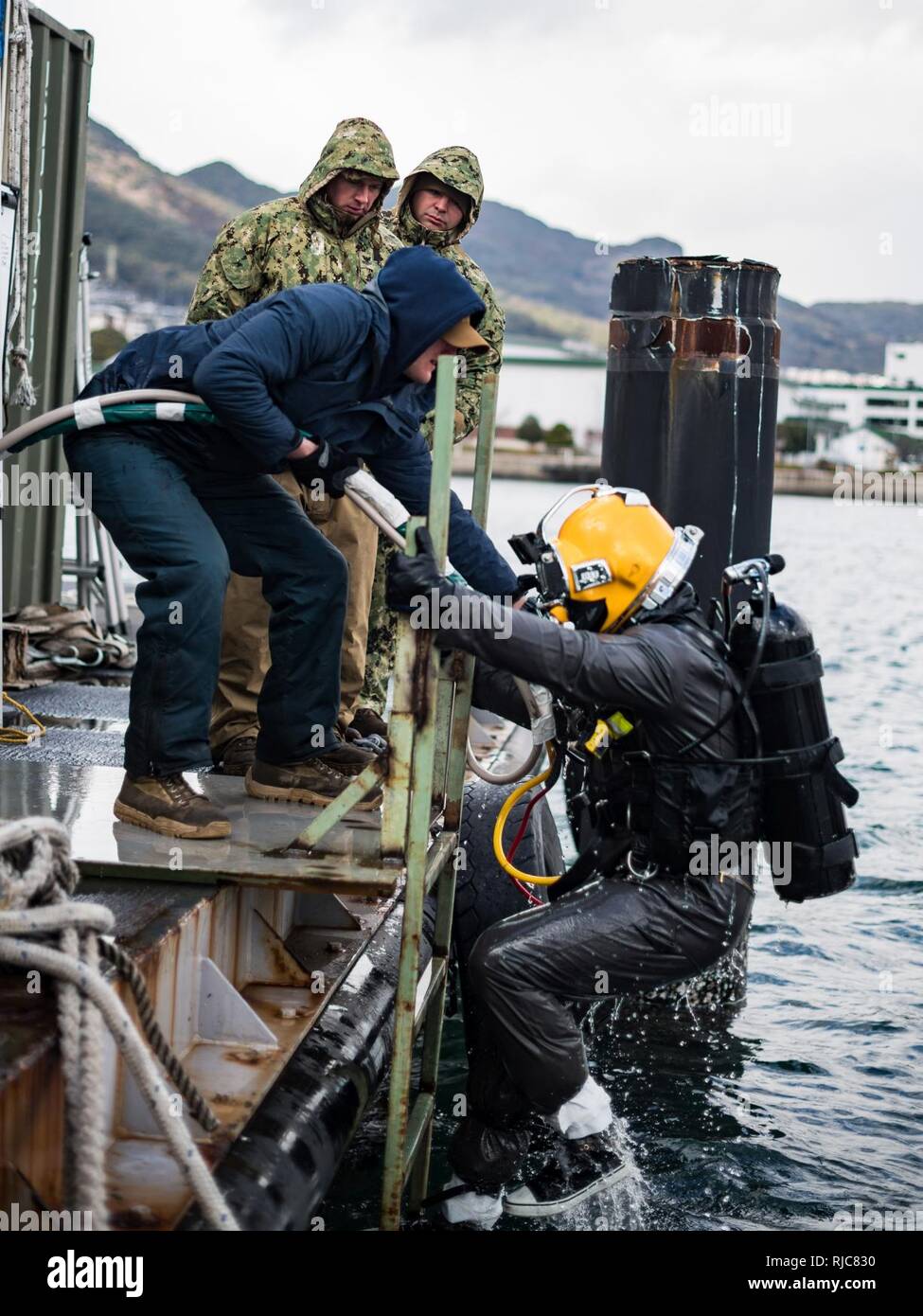 U.S. Navy Seabees and U.S. Navy Divers, assigned to Underwater ...