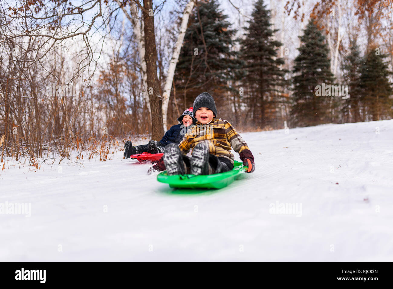 Two boys sledging hi-res stock photography and images - Alamy