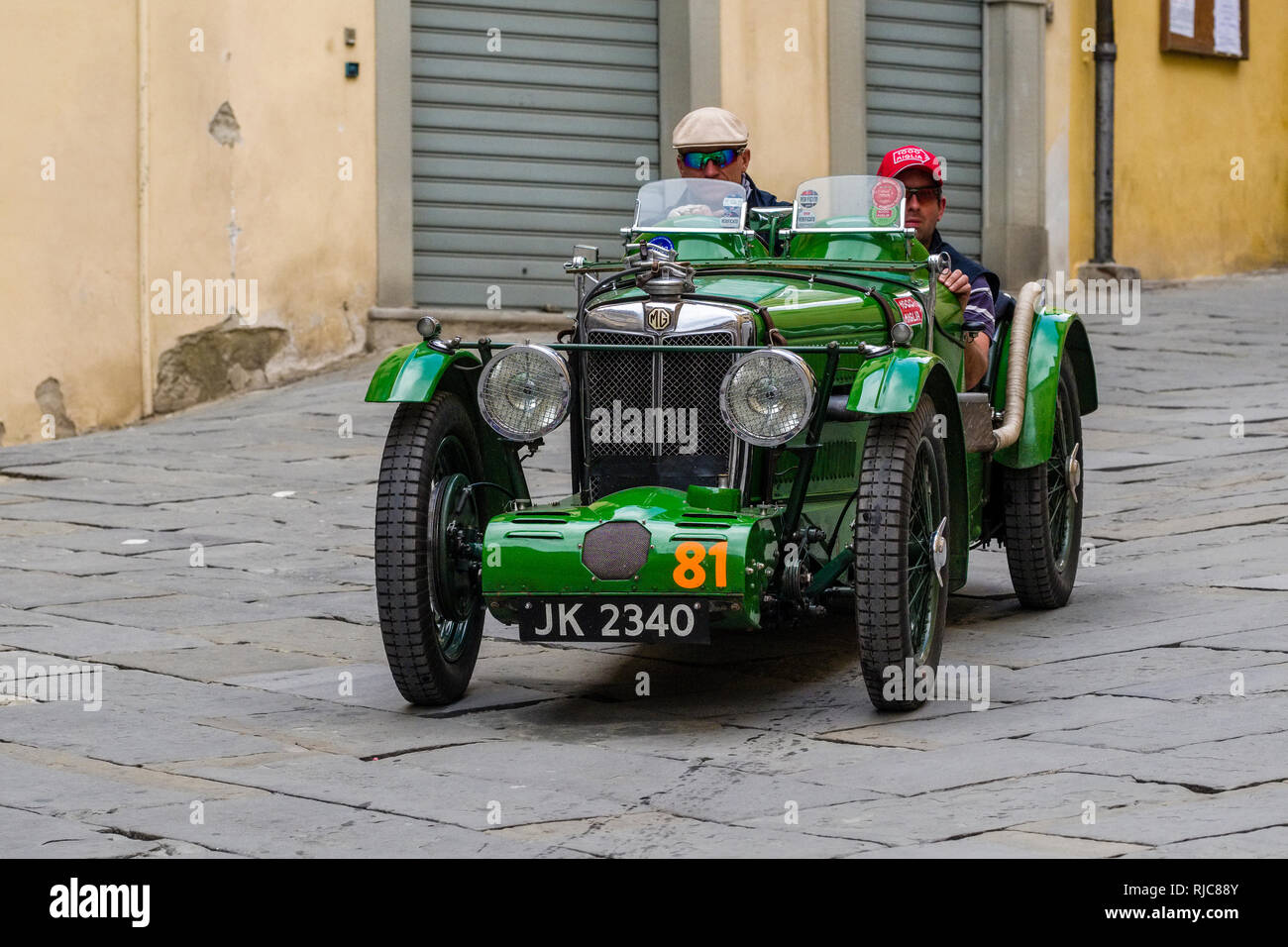 A vintage car, joining the rallye Mille Miglia, driving through the ...