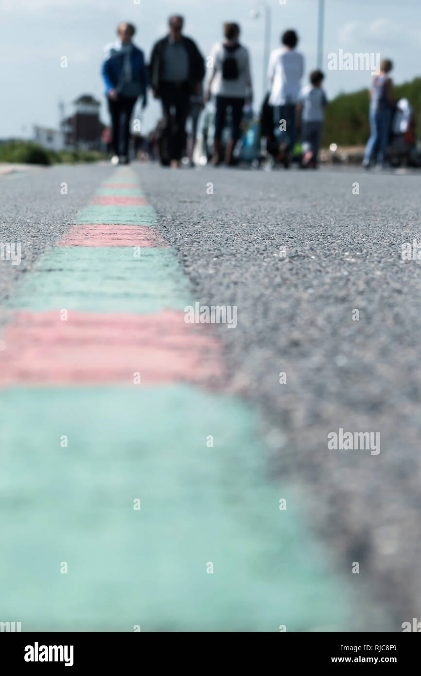 Street view along a painted red and green line with out of focus ...