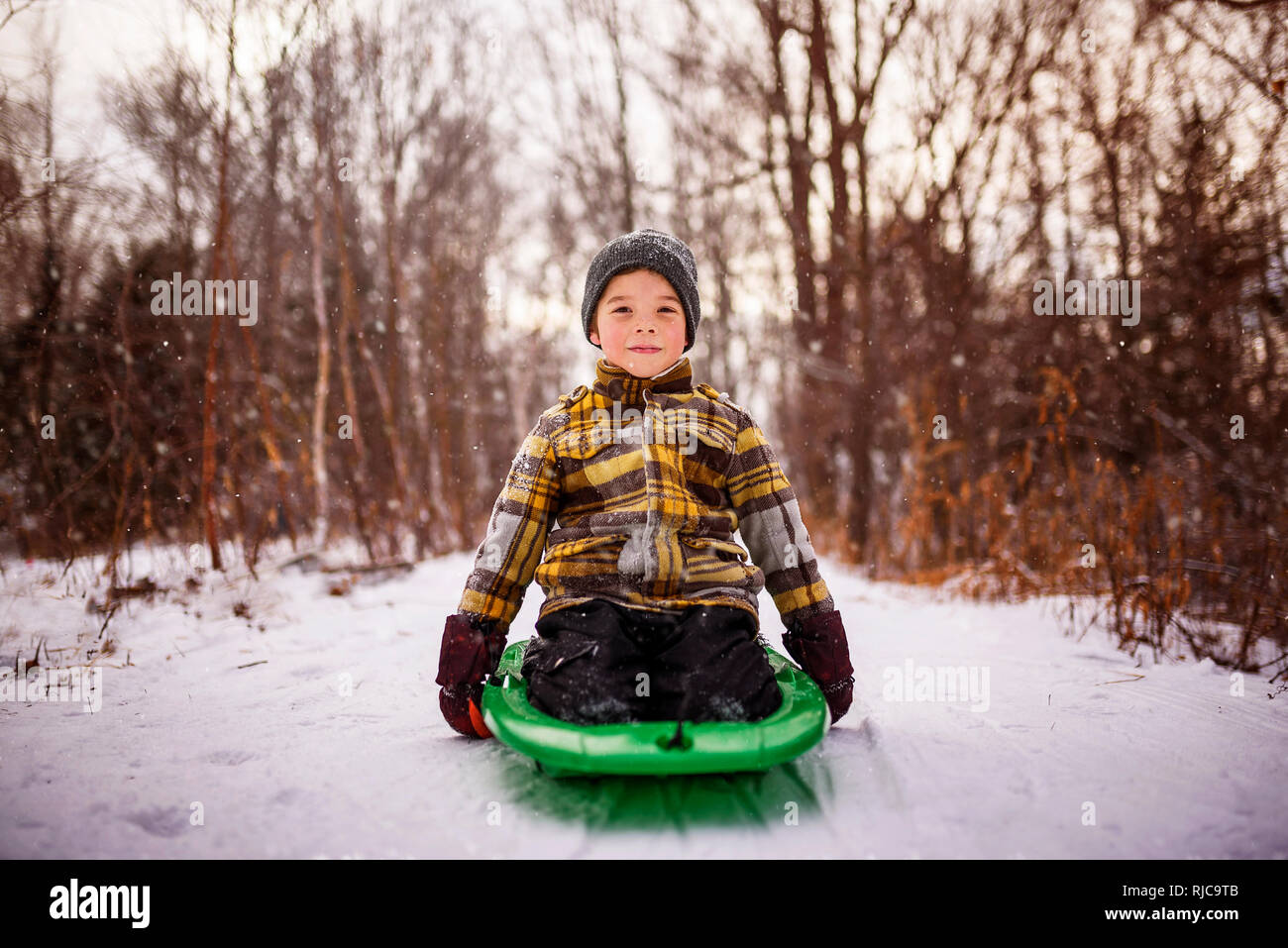 Boy sitting on a sledge, Wisconsin, United States Stock Photo - Alamy