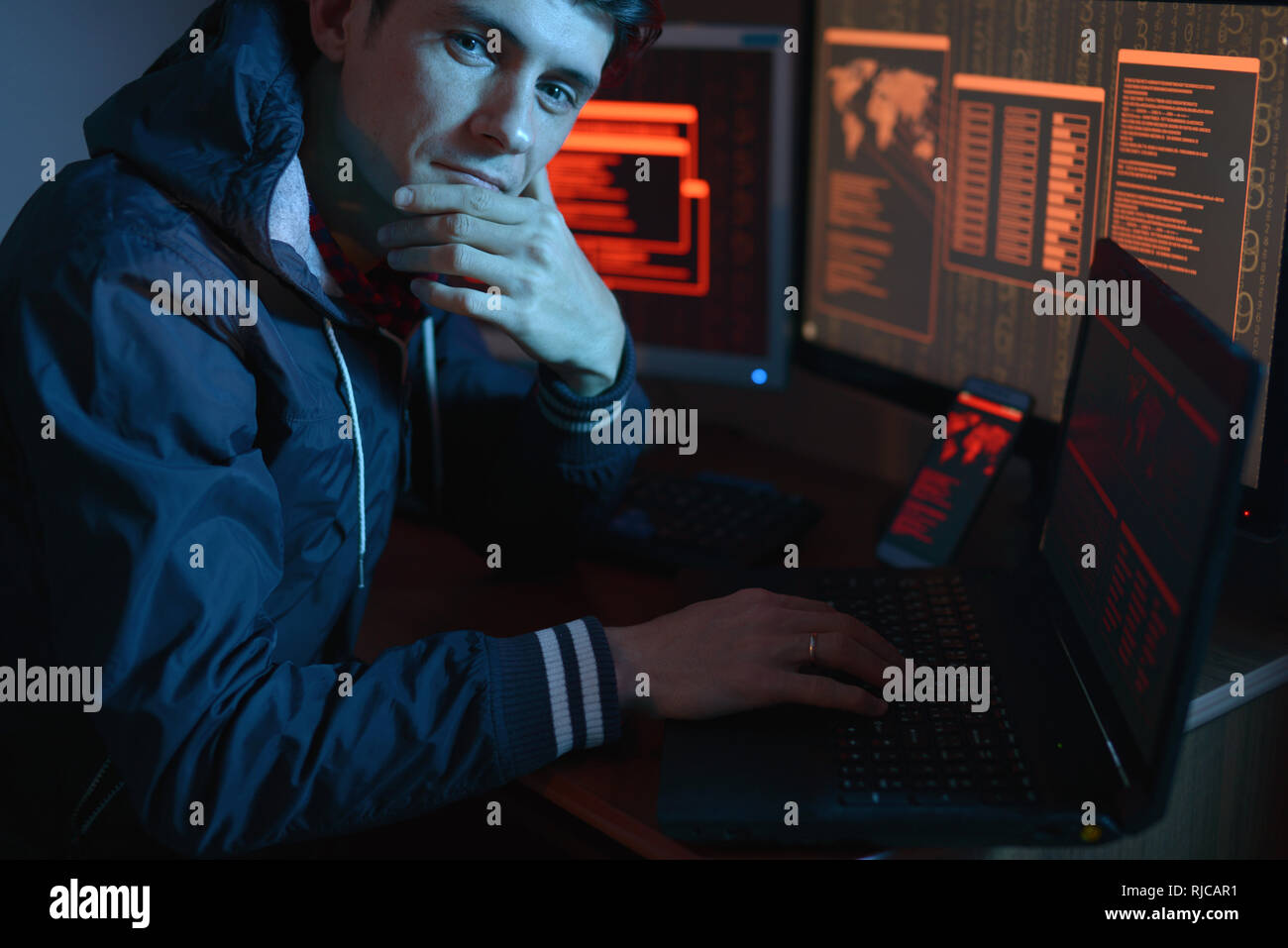 Male In The Hood Looking In The Camera Hacker Attacks And Online Fraud In The Dark On The