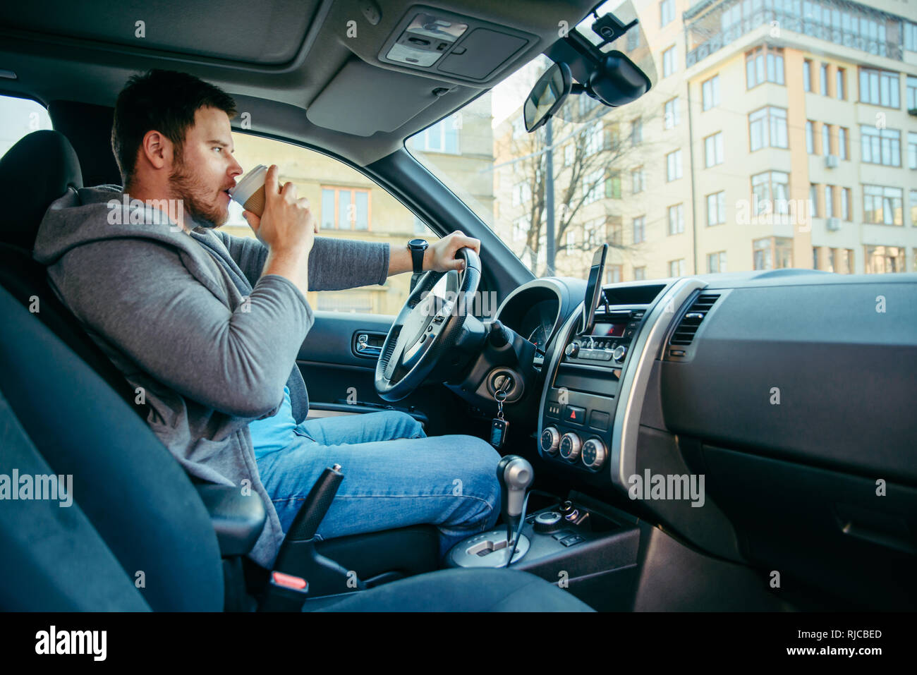 man driving car and drinking coffee. lifestyle. road trip Stock Photo ...
