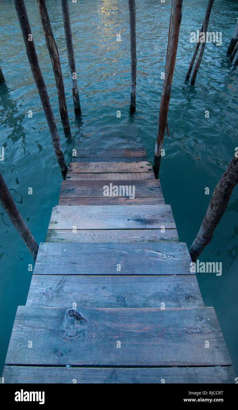 Wooden ladder entering the water in a Venice canal Stock Photo - Alamy