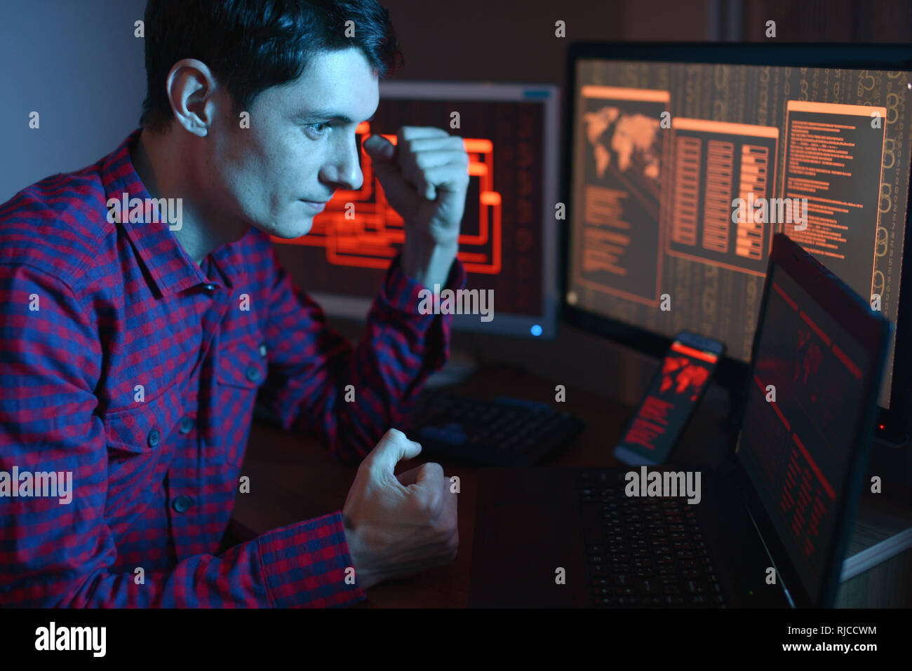Male hacker celebrates success with a hand gesture. A successful ...