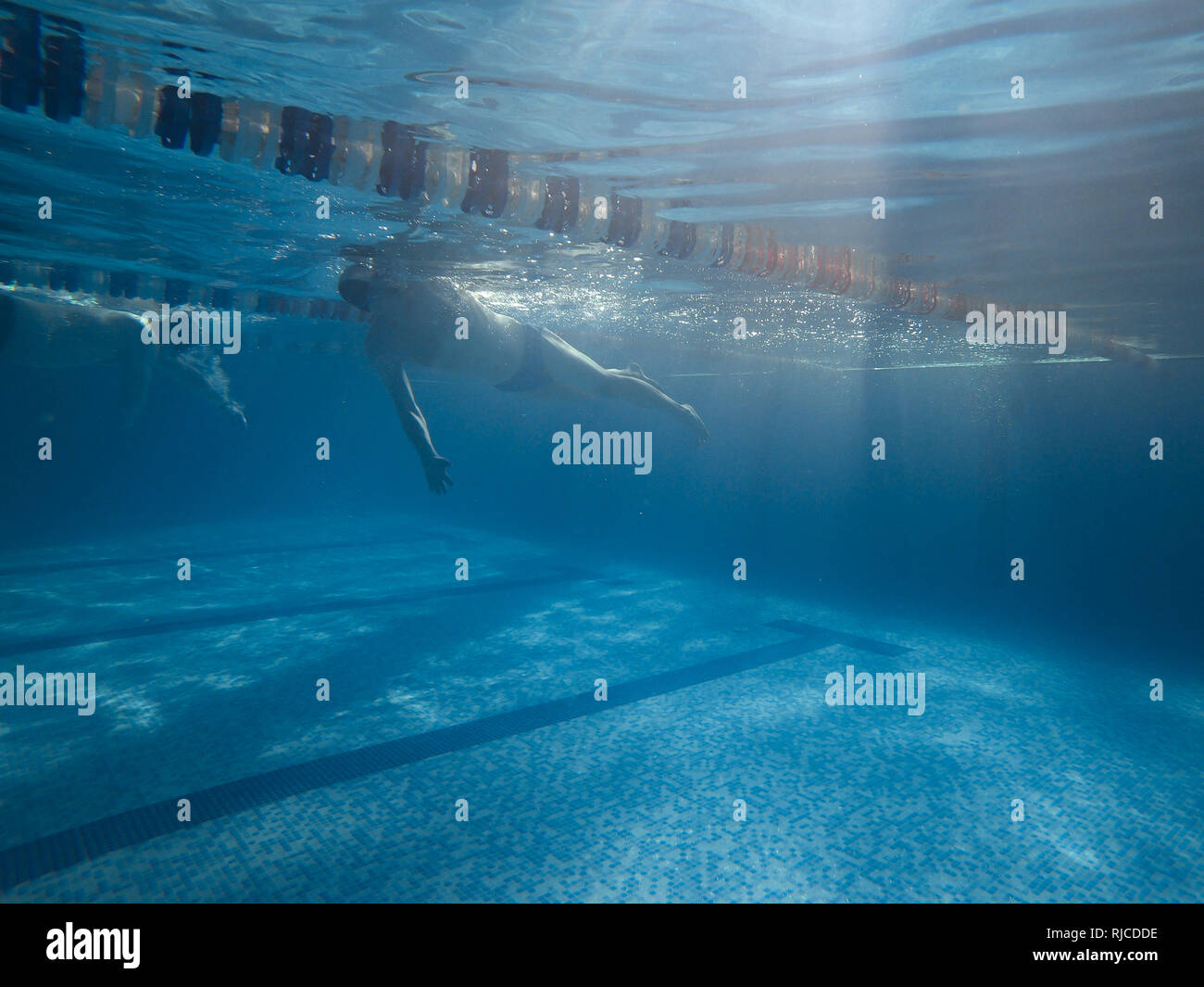 people swimming in pool view from the underwater. sporty lifestyle ...
