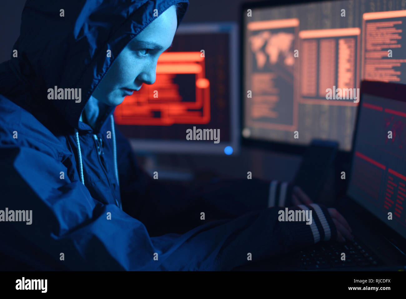 Girl Hacker In A Hood Typing Program Code While Committing A Cybercrime 4358
