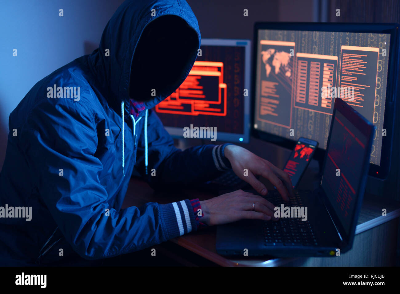 An anonymous hacker with no face typing the code tries to hack the ...