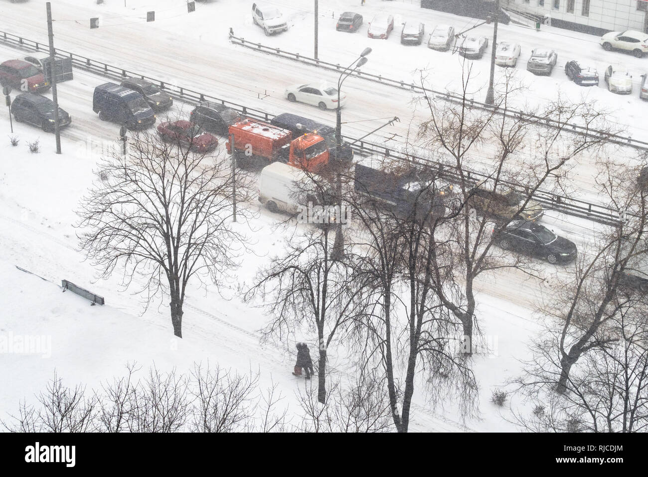 above view of cars drive in snowfall in Moscow city in snowy winter day ...