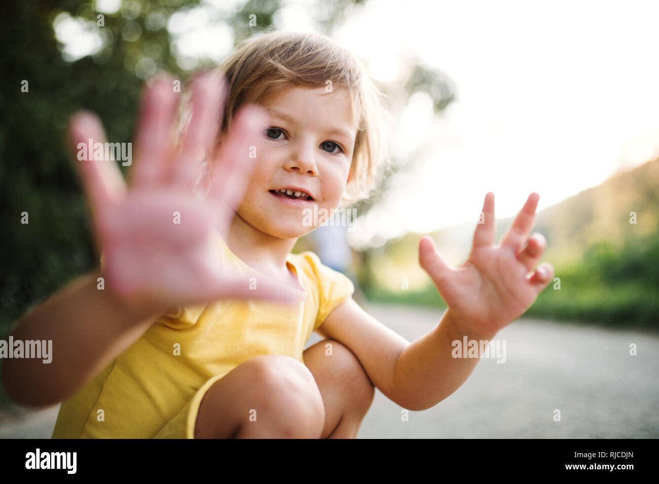 A small cute girl on a road in countryside in sunny summer nature Stock ...