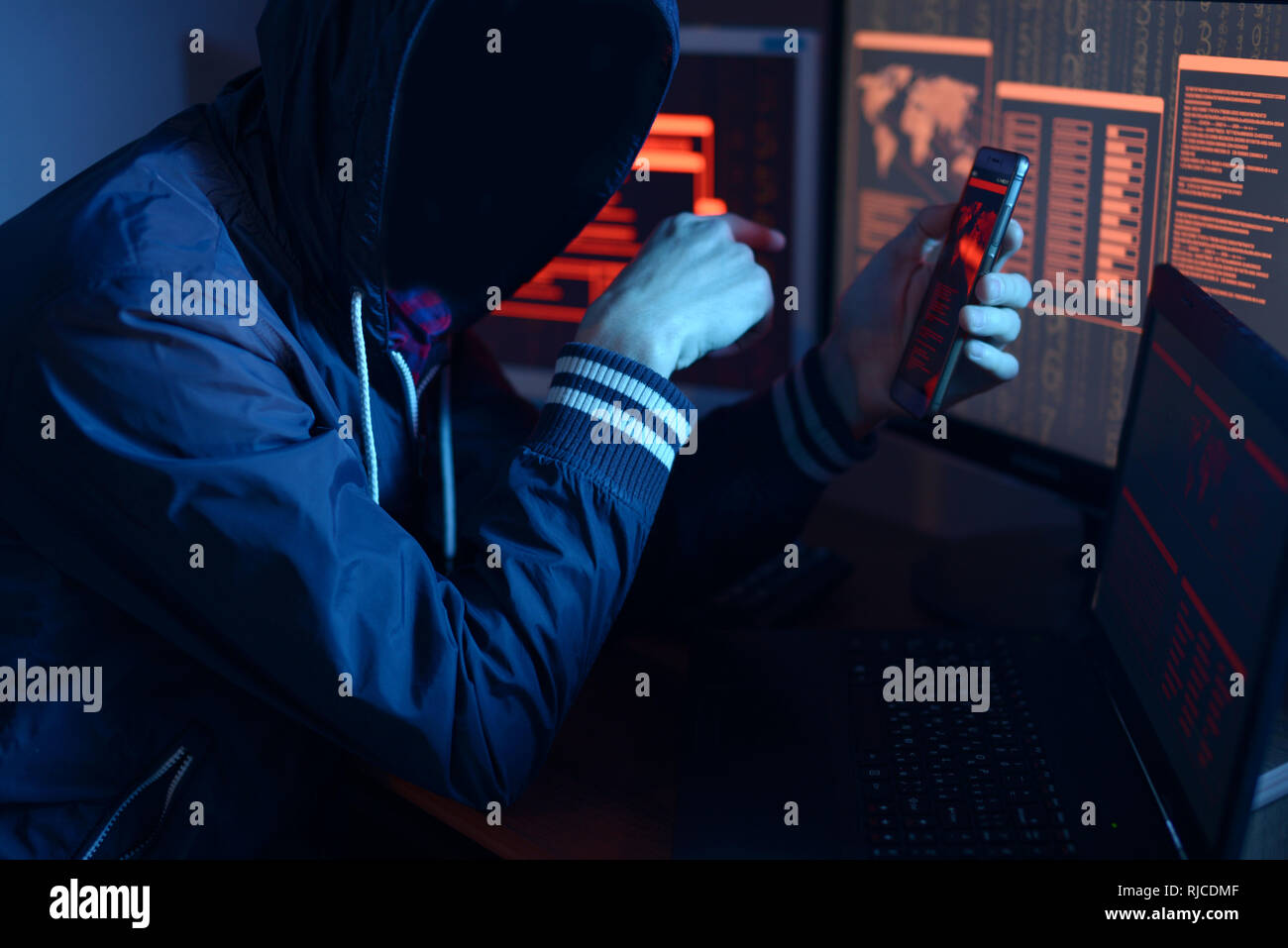 An anonymous hacker with no face typing the code tries to hack the ...
